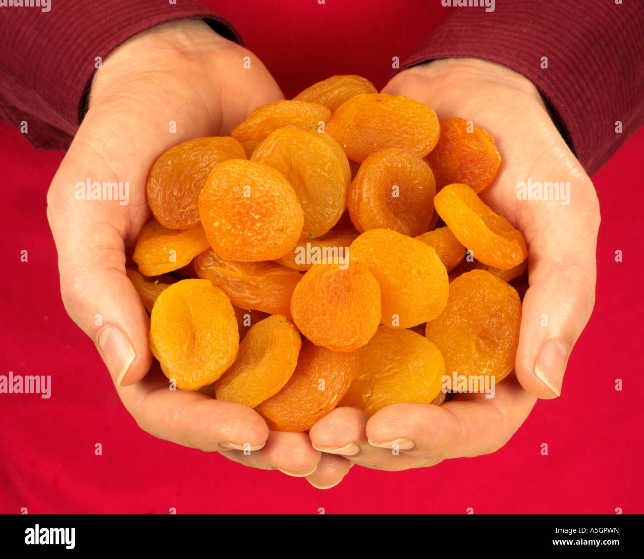 MAN HOLDING DRIED APRICOTS Stock Photo - Alamy