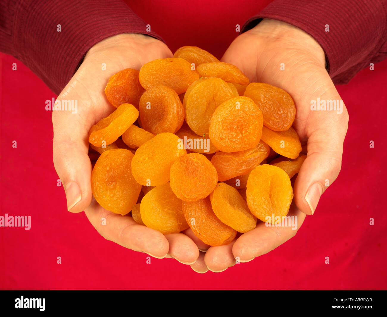 MAN HOLDING DRIED APRICOTS Stock Photo - Alamy