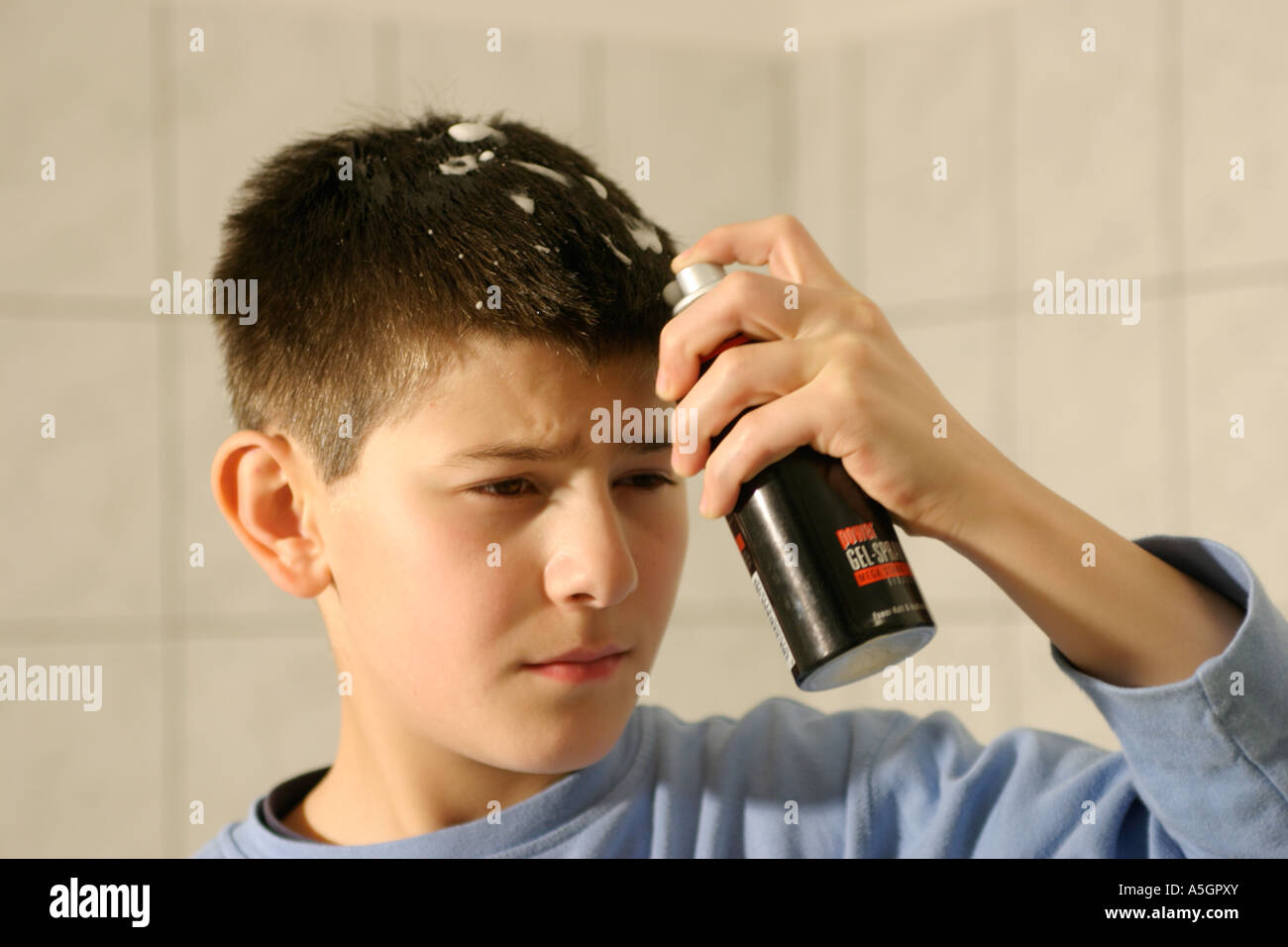 portrait of a young boy gelling his hair Stock Photo - Alamy