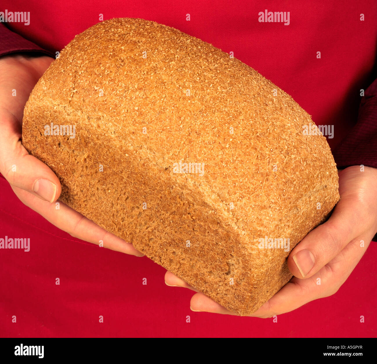 MAN HOLDING WHOLEMEAL LOAF OF BREAD Stock Photo - Alamy