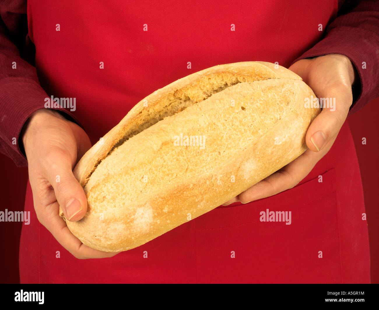 MAN HOLDING SOURDOUGH BREAD Stock Photo - Alamy