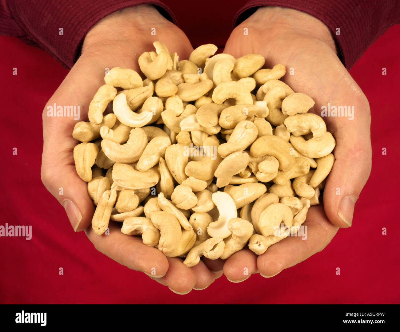 MAN HOLDING CASHEW NUTS Stock Photo - Alamy