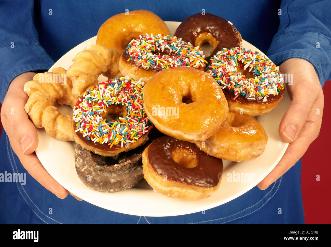 Hands holding doughnuts hi-res stock photography and images - Alamy
