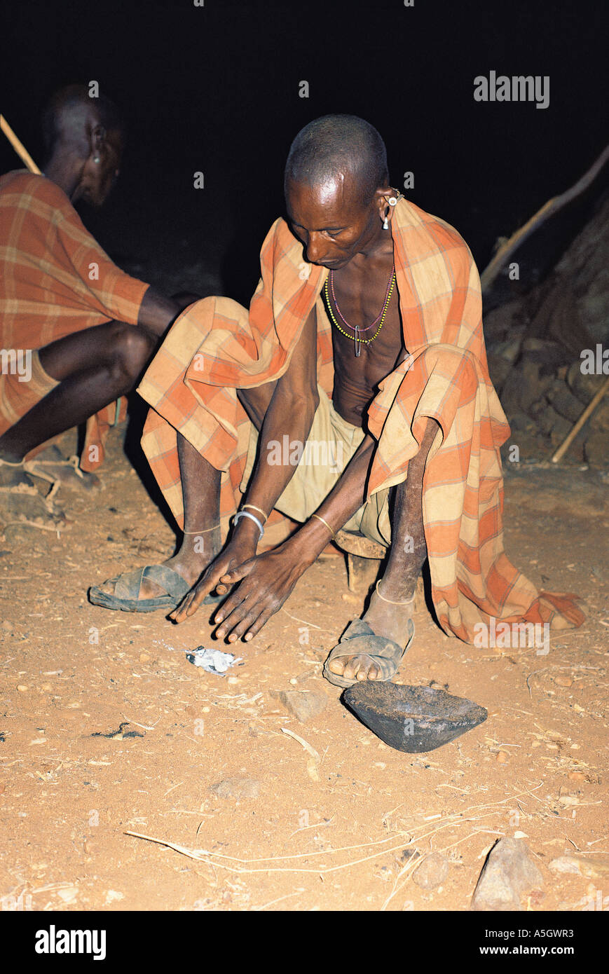Rendille man burning fragrant herbs to celebrate the new moon Korr ...