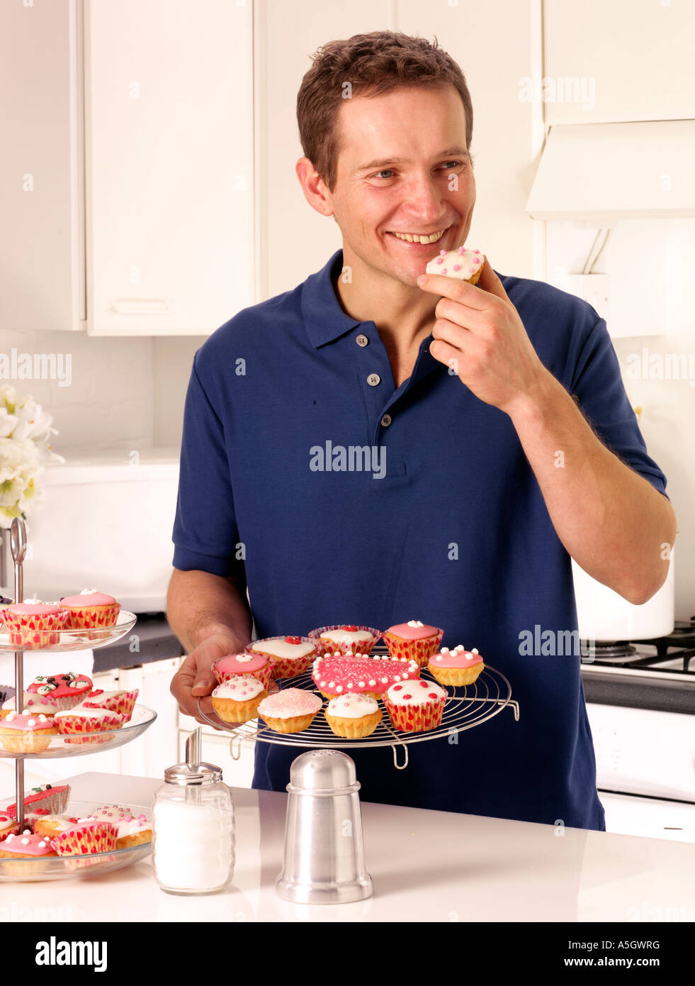 MAN IN KITCHEN EATING CAKE Stock Photo - Alamy