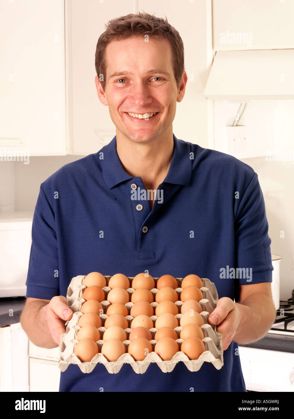 MAN IN KITCHEN WITH TRAY OF EGGS Stock Photo - Alamy