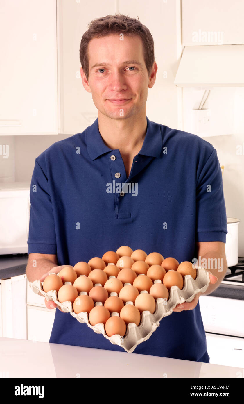 MAN IN KITCHEN WITH TRAY OF EGGS Stock Photo - Alamy
