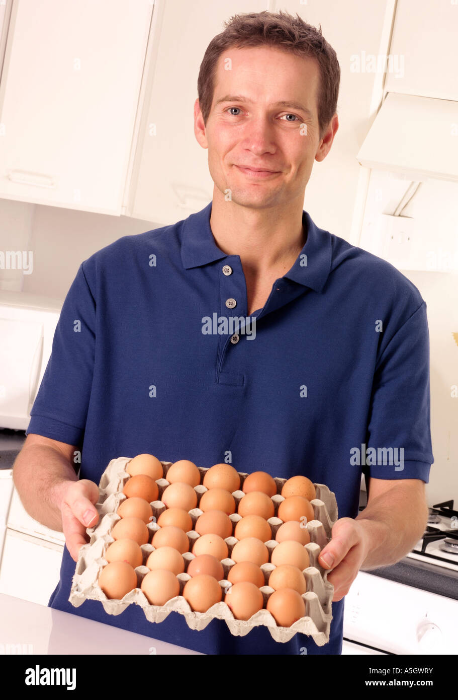 MAN IN KITCHEN WITH TRAY OF EGGS Stock Photo - Alamy