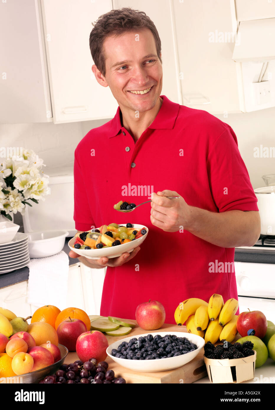 MAN EATING FRUIT SALAD Stock Photo - Alamy