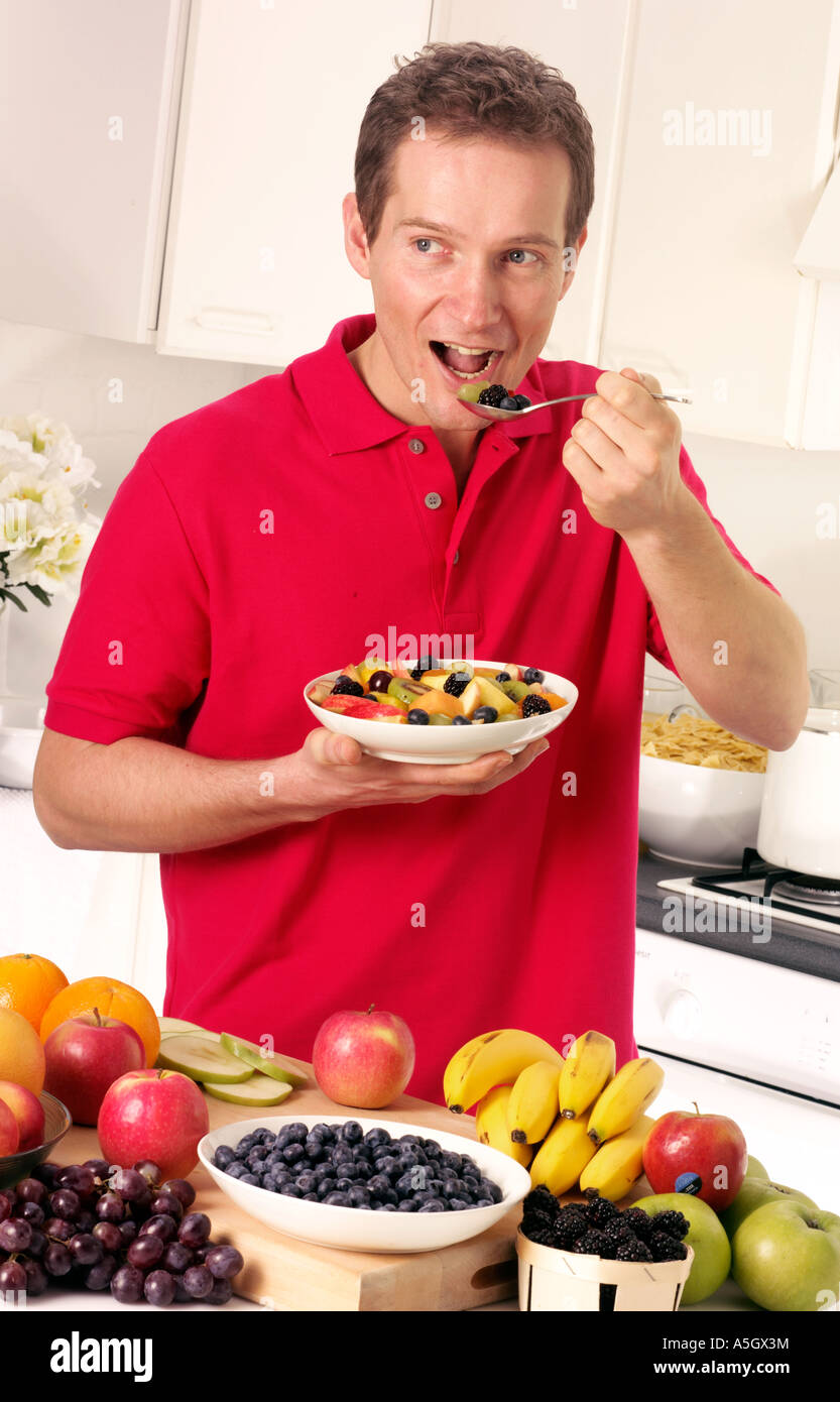 MAN EATING FRUIT SALAD Stock Photo - Alamy