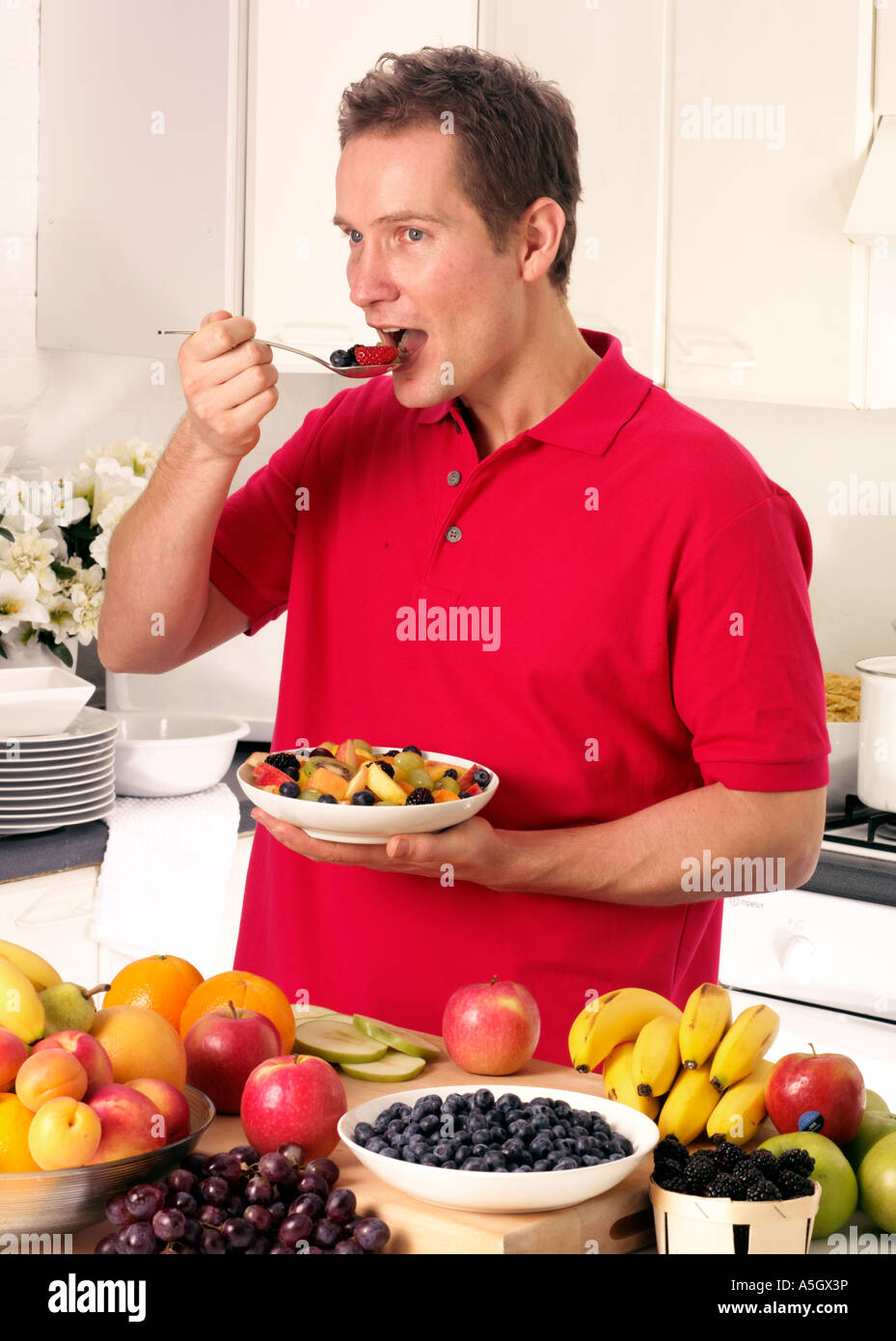 MAN EATING FRUIT SALAD Stock Photo - Alamy