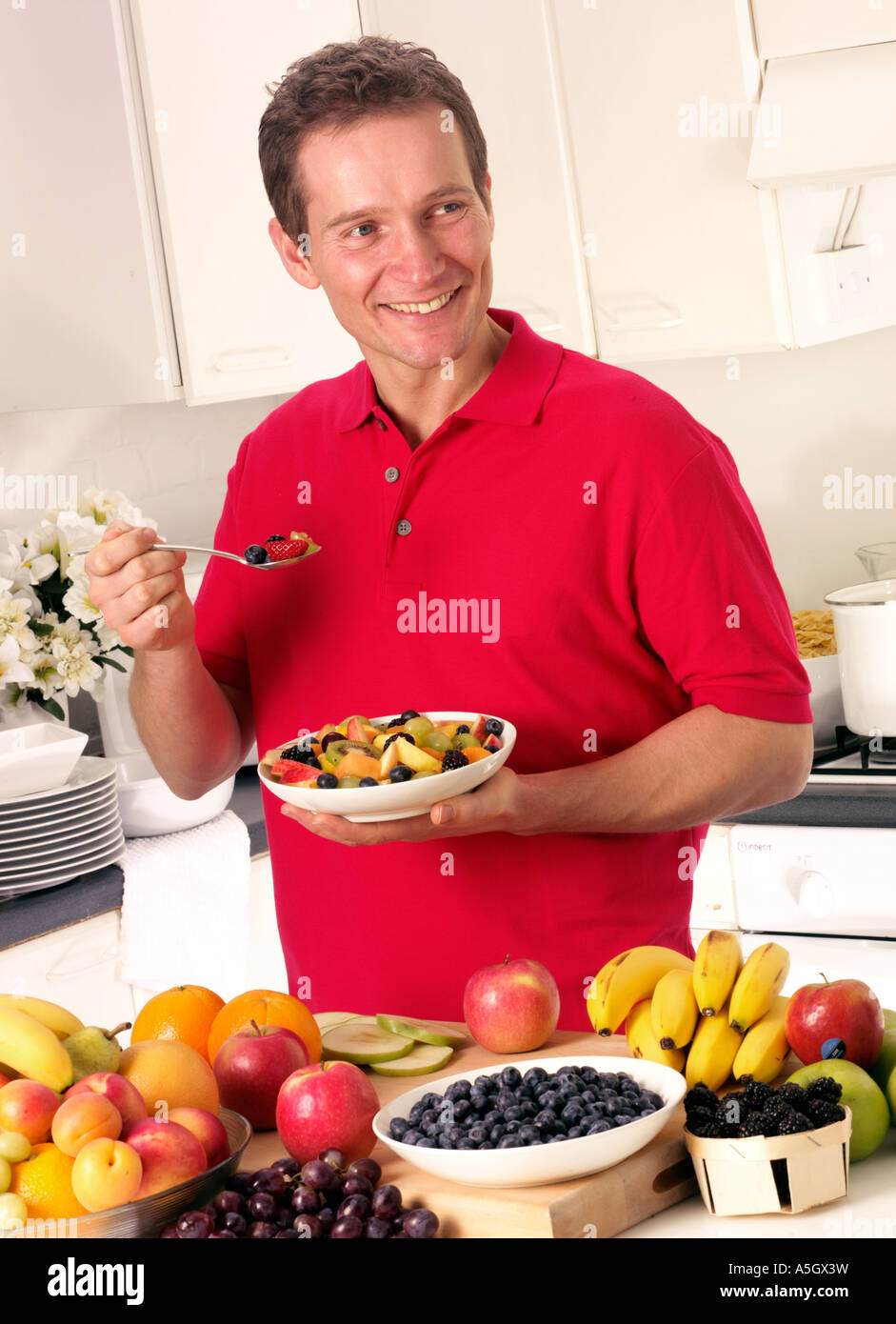 MAN EATING FRUIT SALAD Stock Photo - Alamy