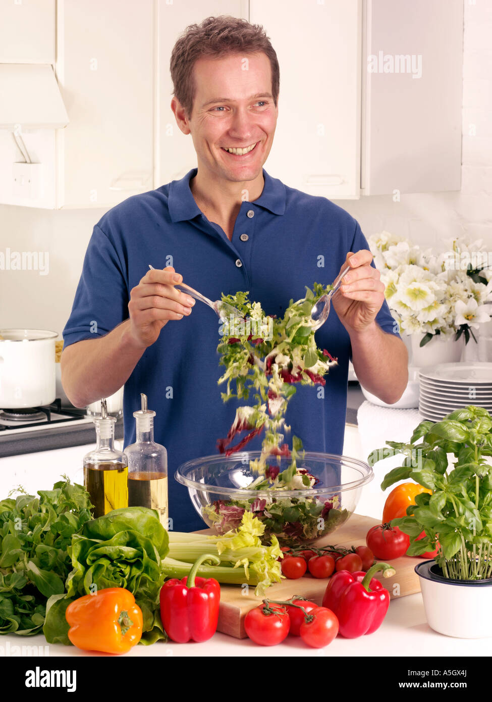 Man kitchen making salad food person fresh green hi-res stock ...