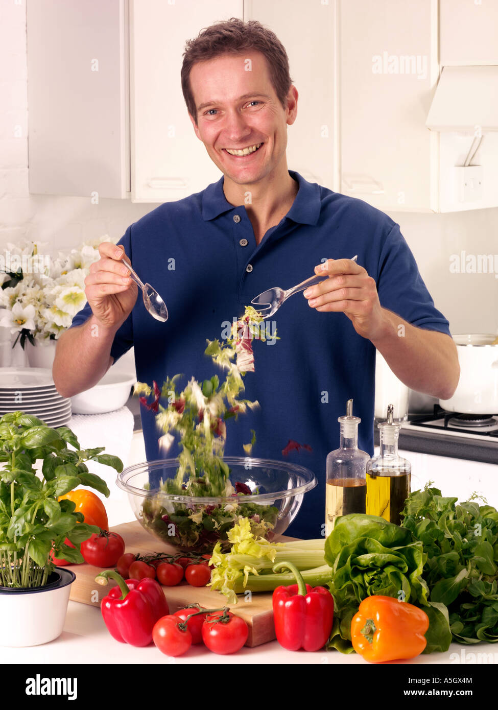 Man kitchen making salad food person fresh green hi-res stock ...