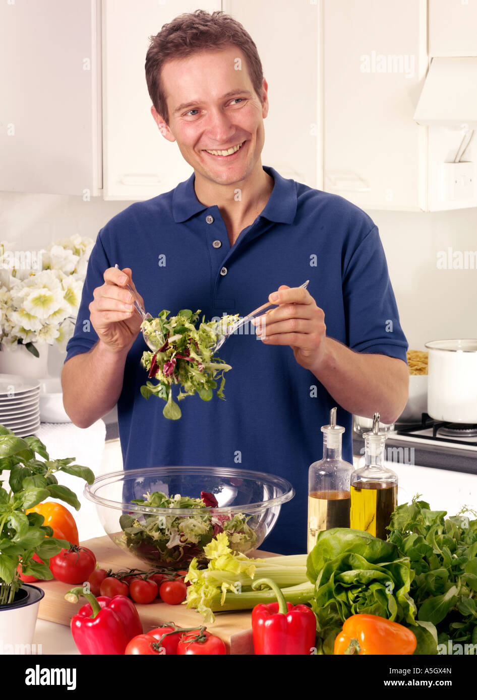 Man kitchen making salad food person fresh green hi-res stock ...