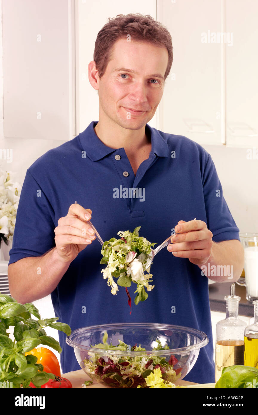 MAN IN KITCHEN MAKING SALAD Stock Photo - Alamy
