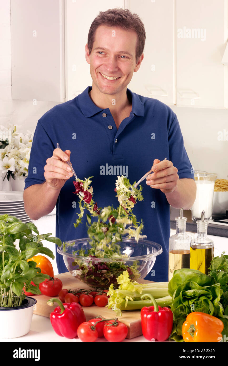 MAN IN KITCHEN MAKING SALAD Stock Photo - Alamy