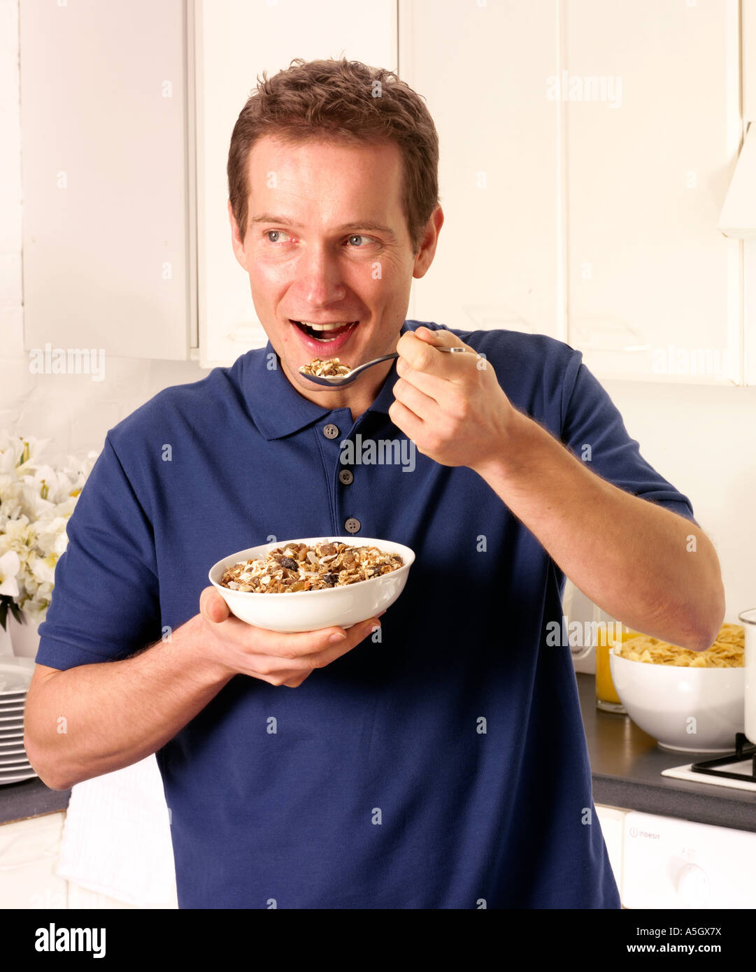 MAN IN KITCHEN EATING MUESLI Stock Photo - Alamy