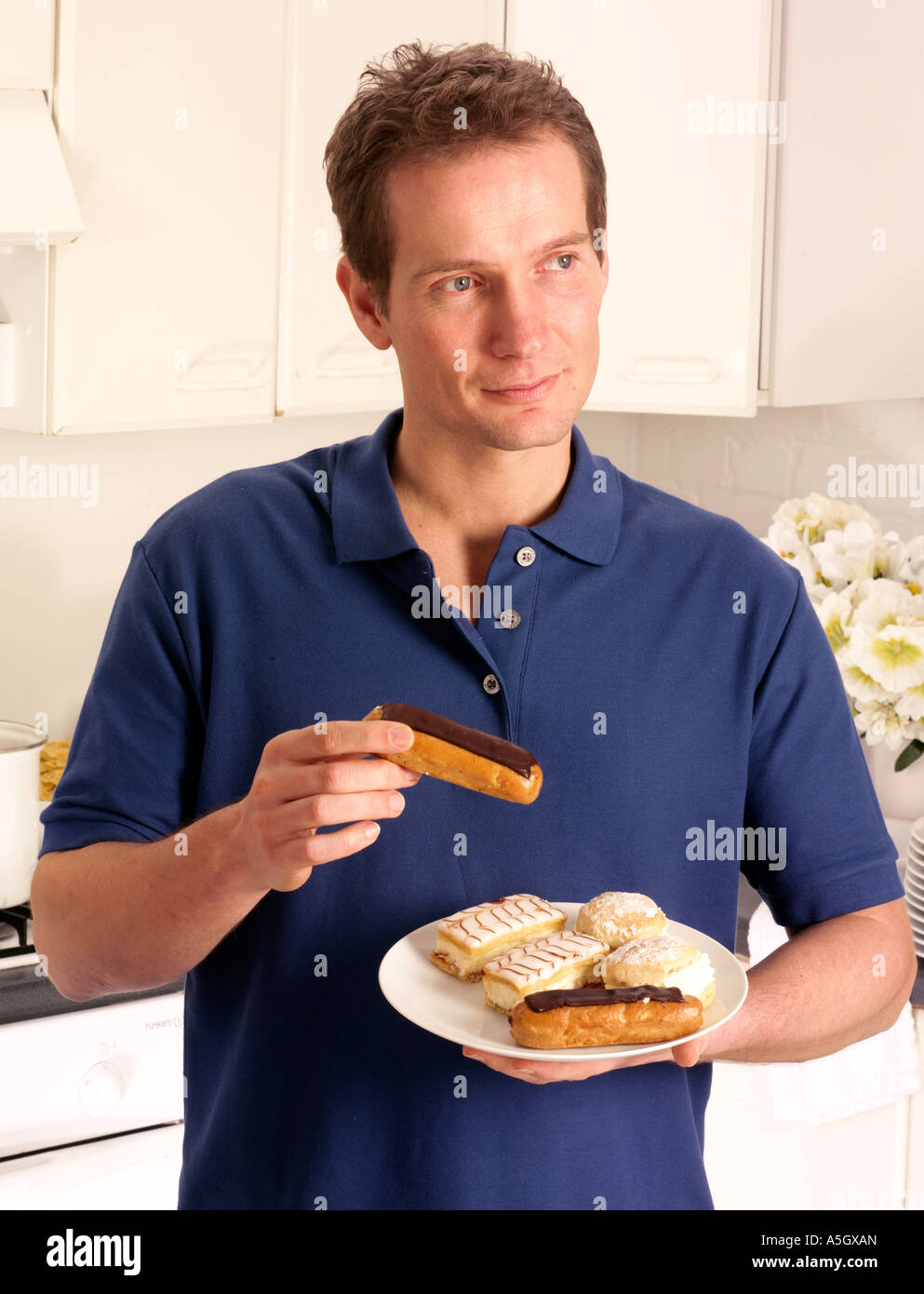 MAN IN KITCHEN WITH CREAM CAKES Stock Photo - Alamy