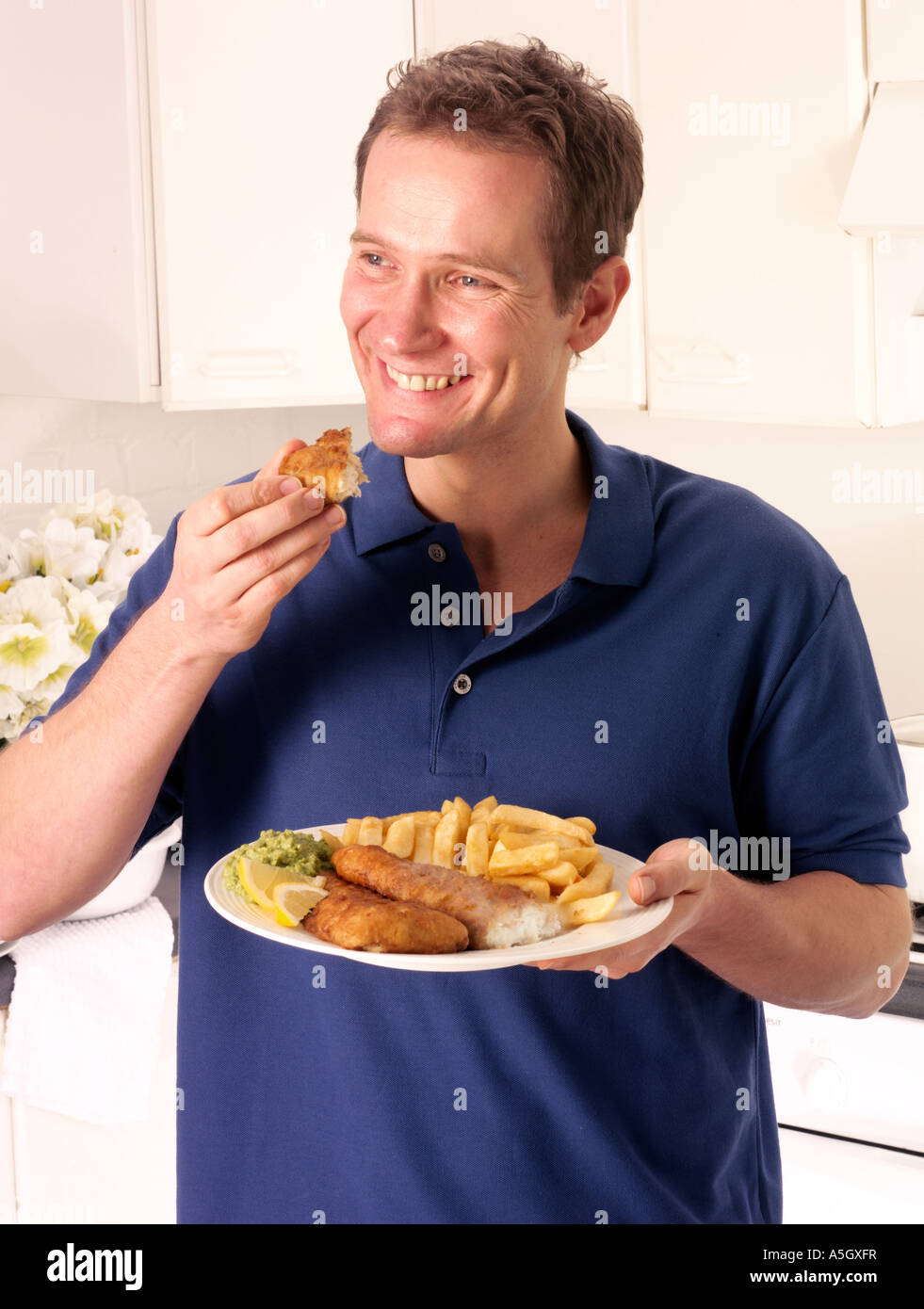 Someone eating fish and chips hi-res stock photography and images - Alamy