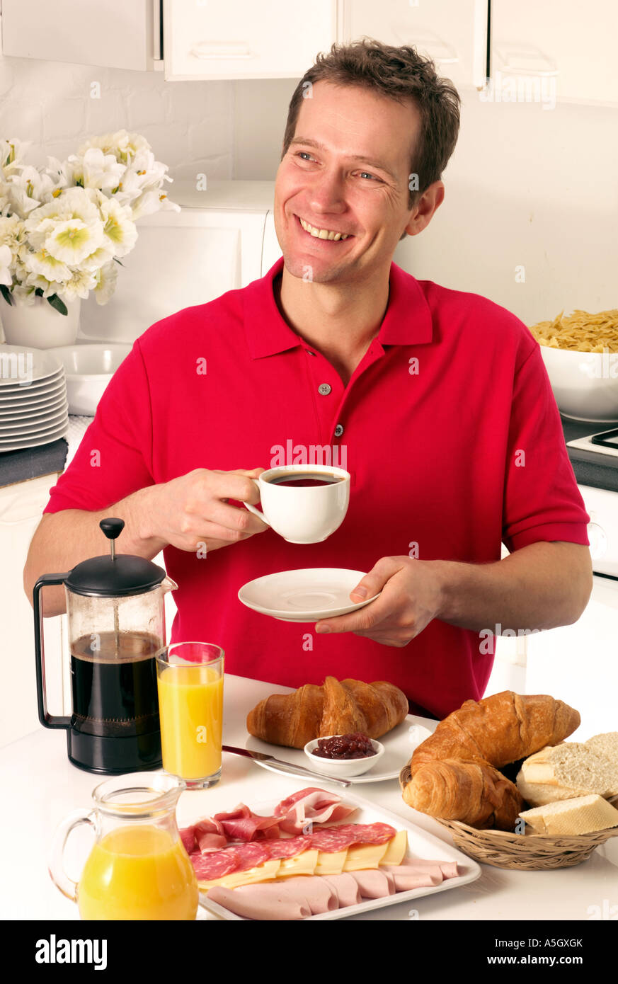 MAN HAVING BREAKFAST AND DRINKING COFFEE Stock Photo - Alamy