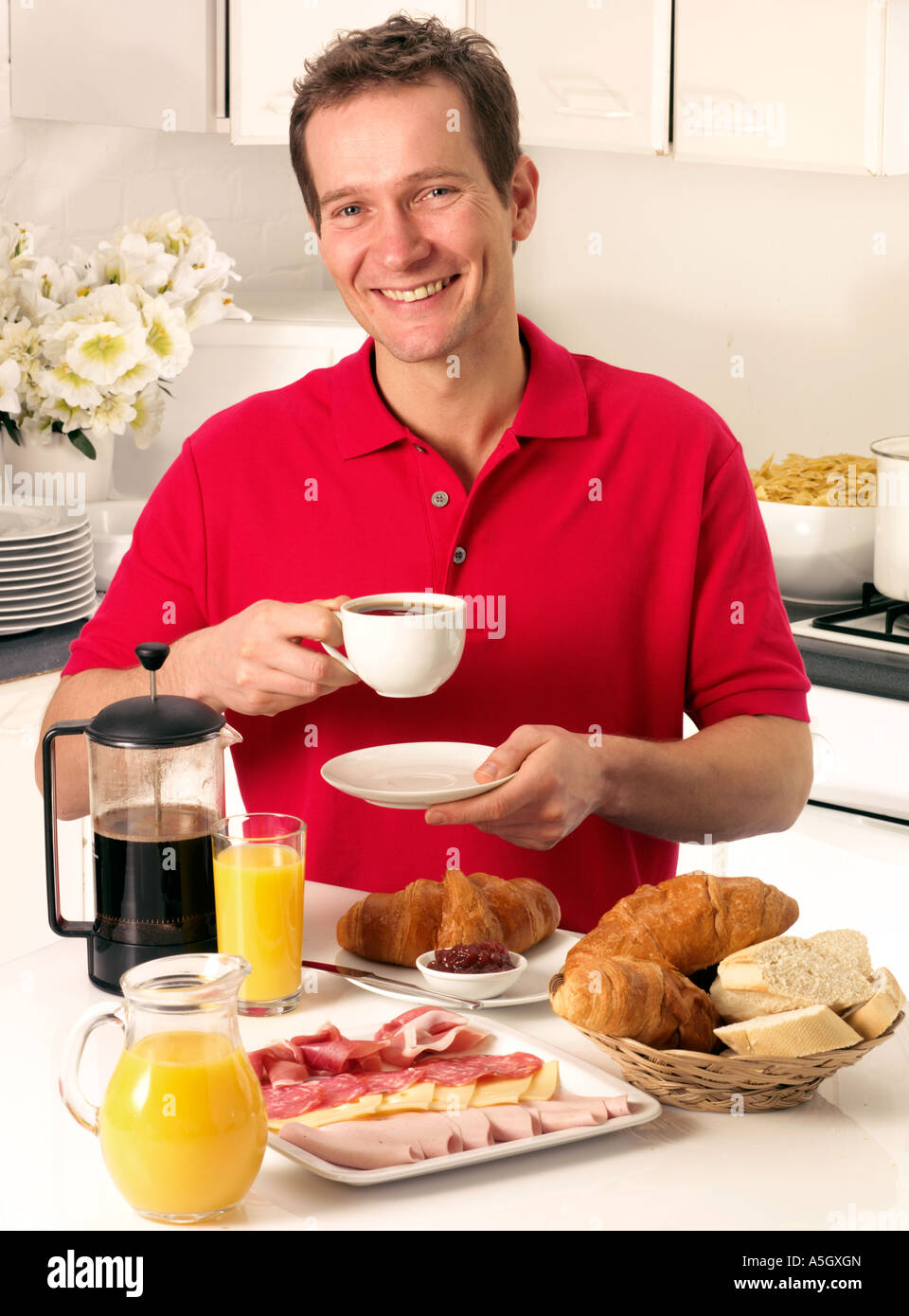 MAN HAVING BREAKFAST AND DRINKING COFFEE Stock Photo - Alamy