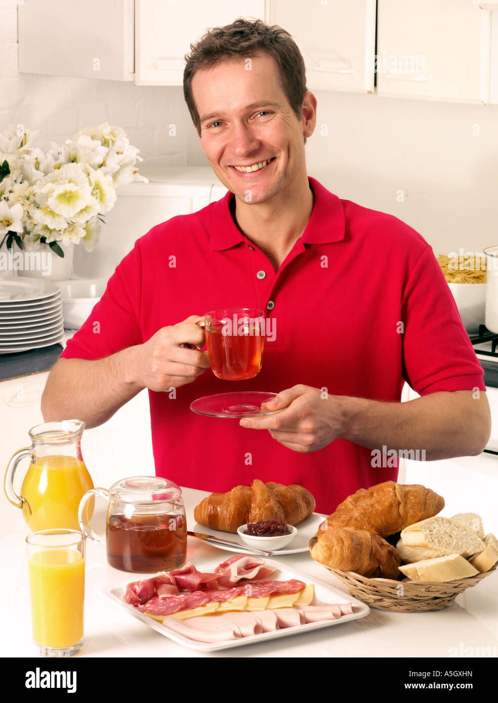 MAN HAVING BREAKFAST AND DRINKING TEA Stock Photo - Alamy