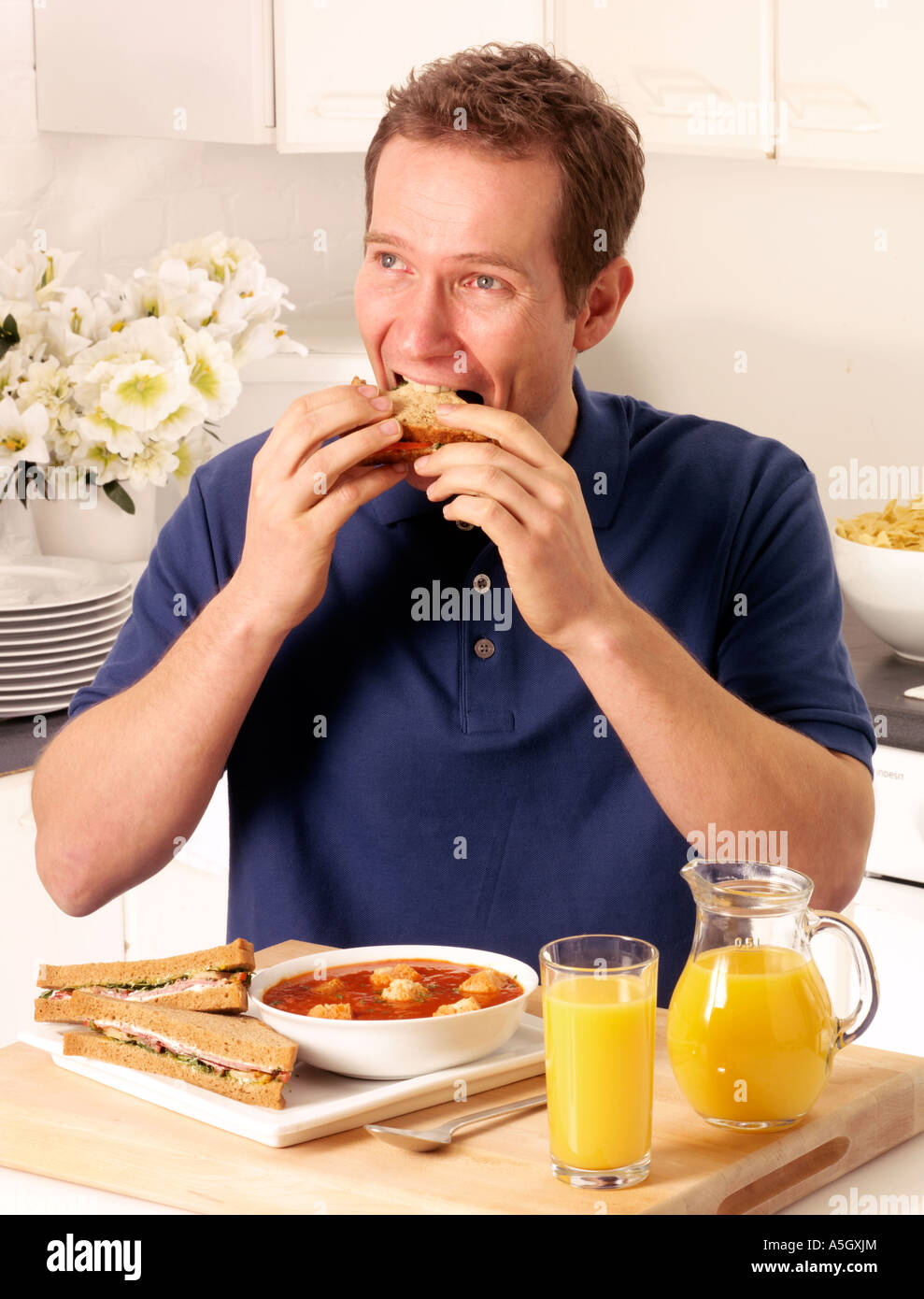 Man eating sandwich standing hi-res stock photography and images - Alamy