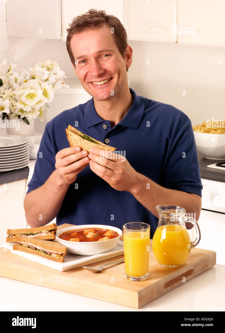 Happy man eating solo hi-res stock photography and images - Alamy