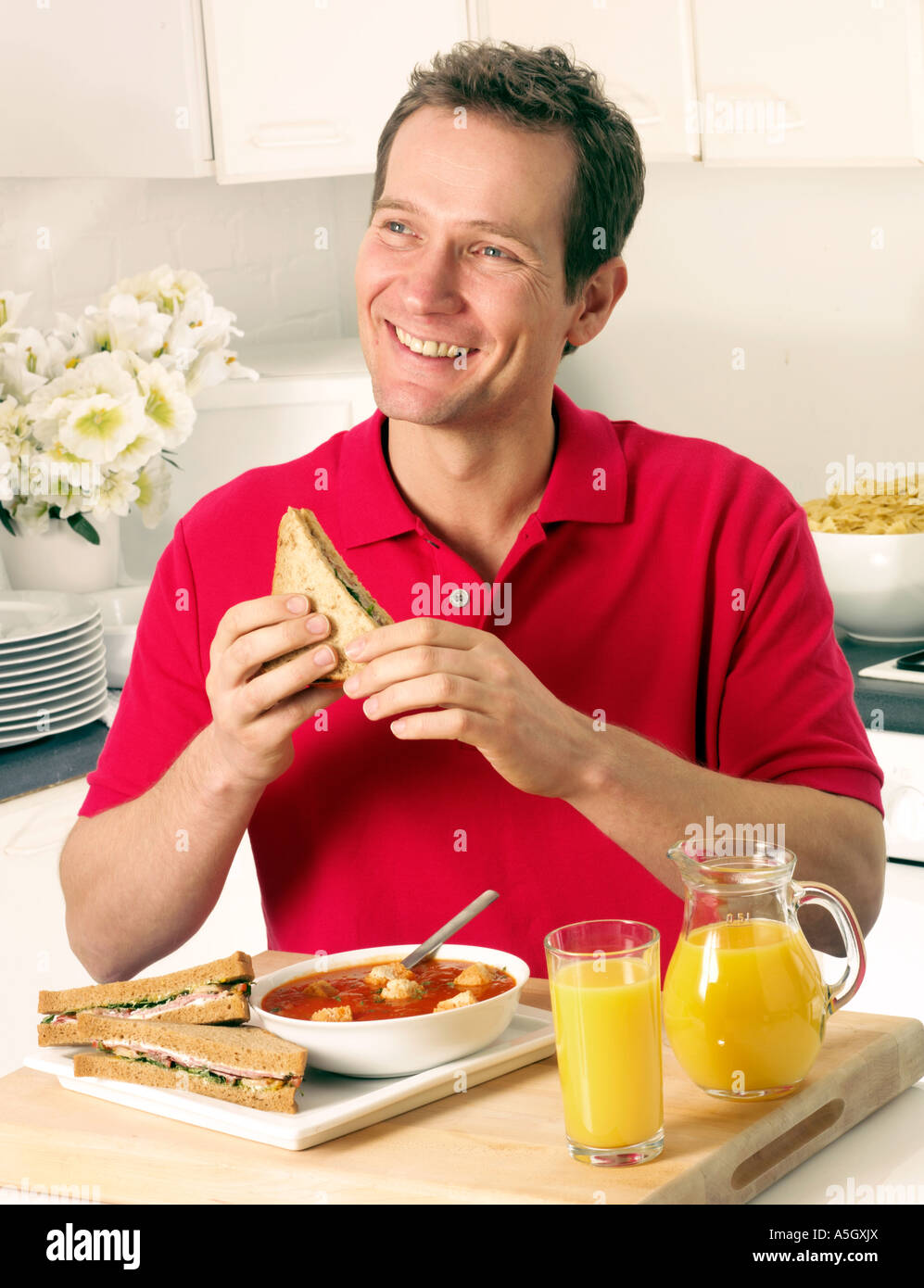 Happy man eating solo hi-res stock photography and images - Alamy