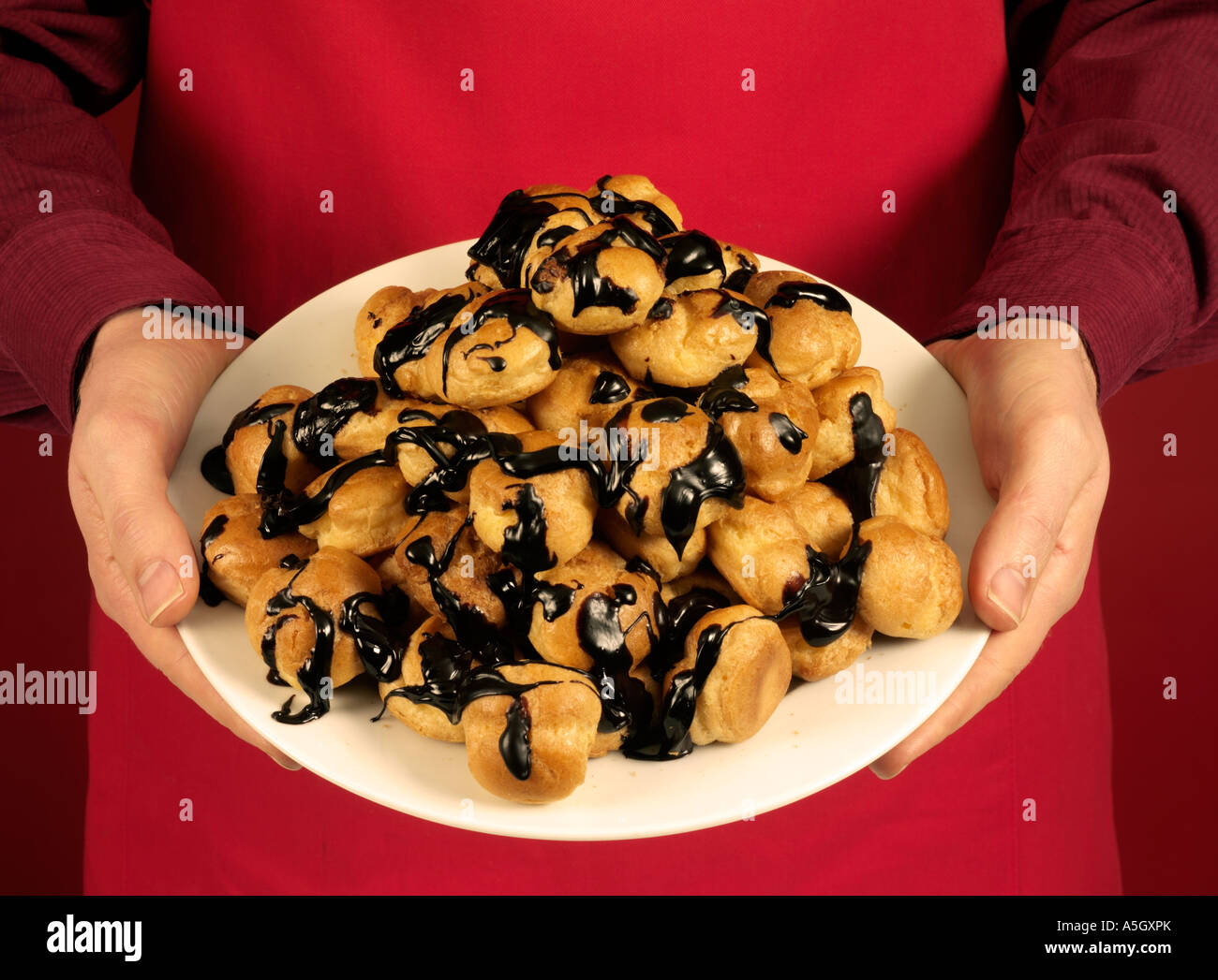 Man holding plate french profiteroles food hi-res stock photography and ...