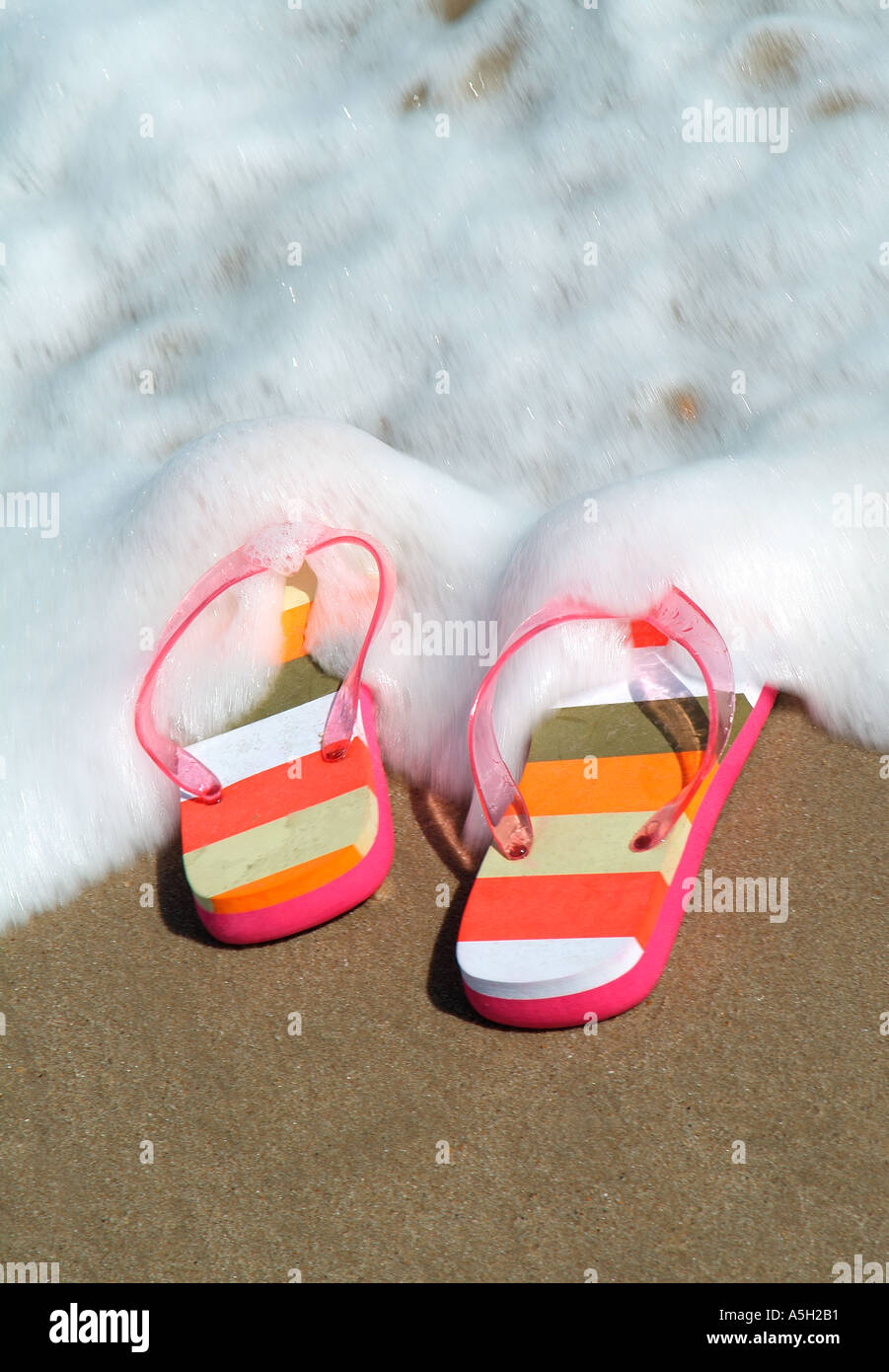 flip flops on beach in sea water Stock Photo - Alamy