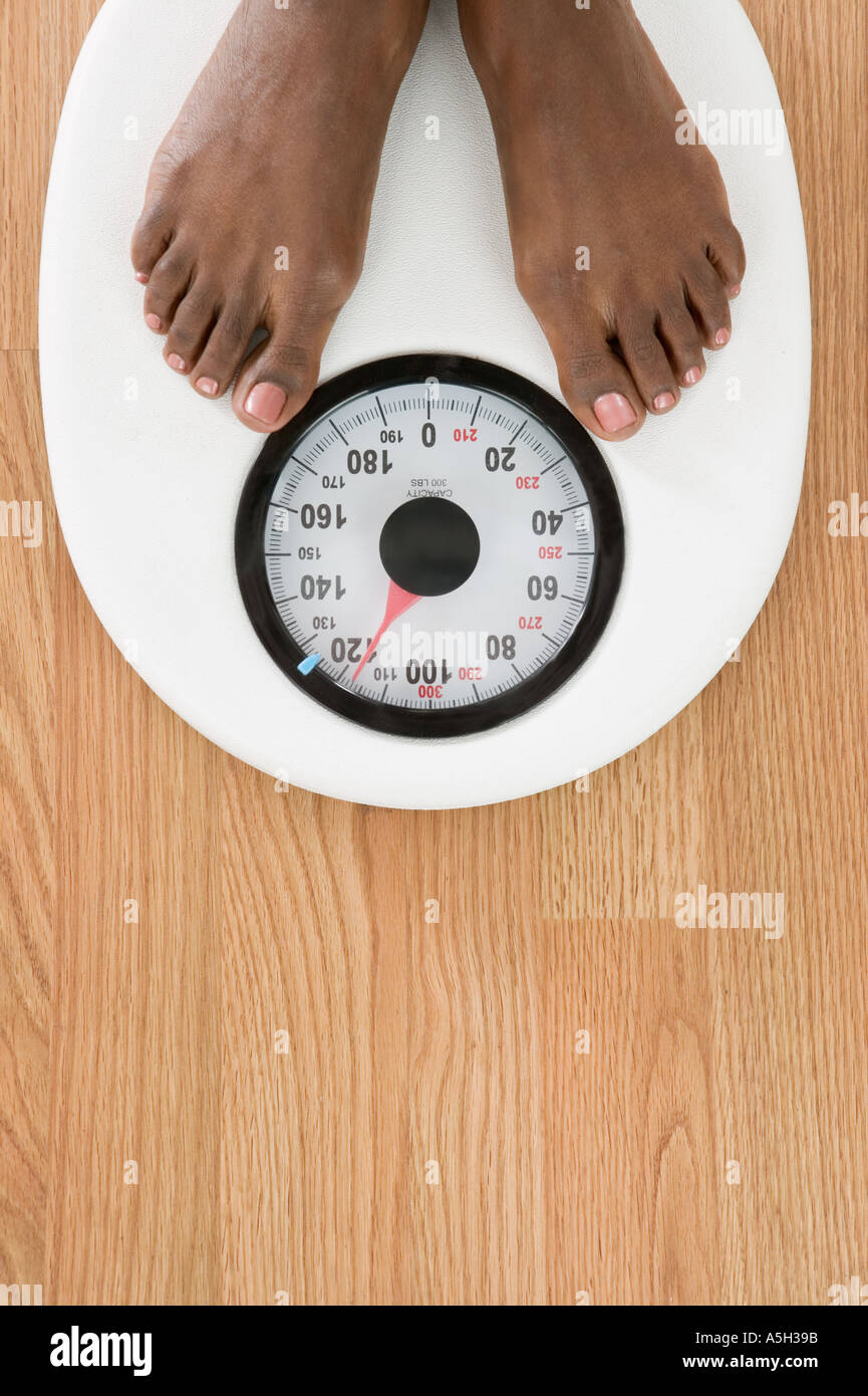 Overhead view of feet on a scale Stock Photo - Alamy