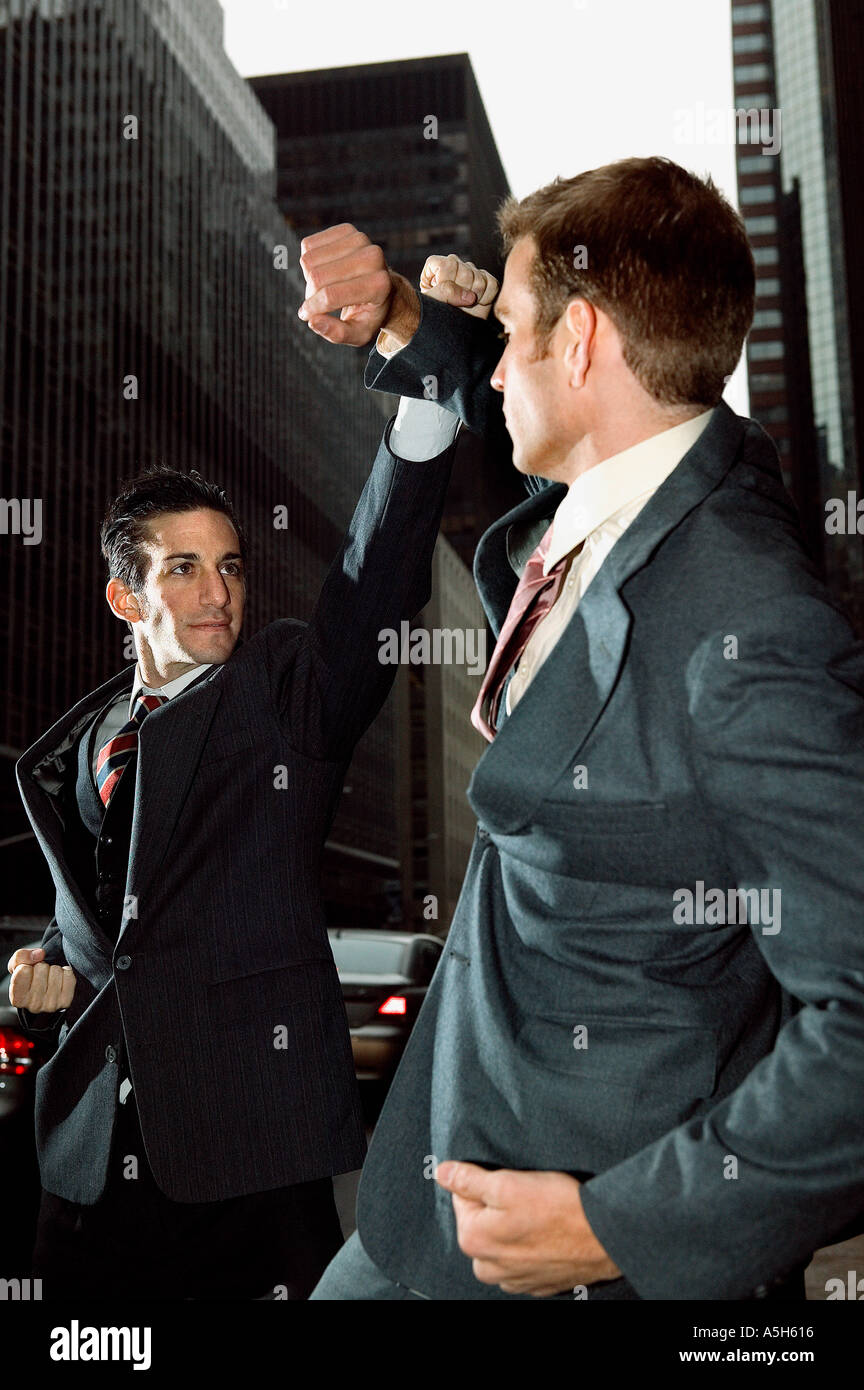 Businessmen fighting in street Stock Photo - Alamy