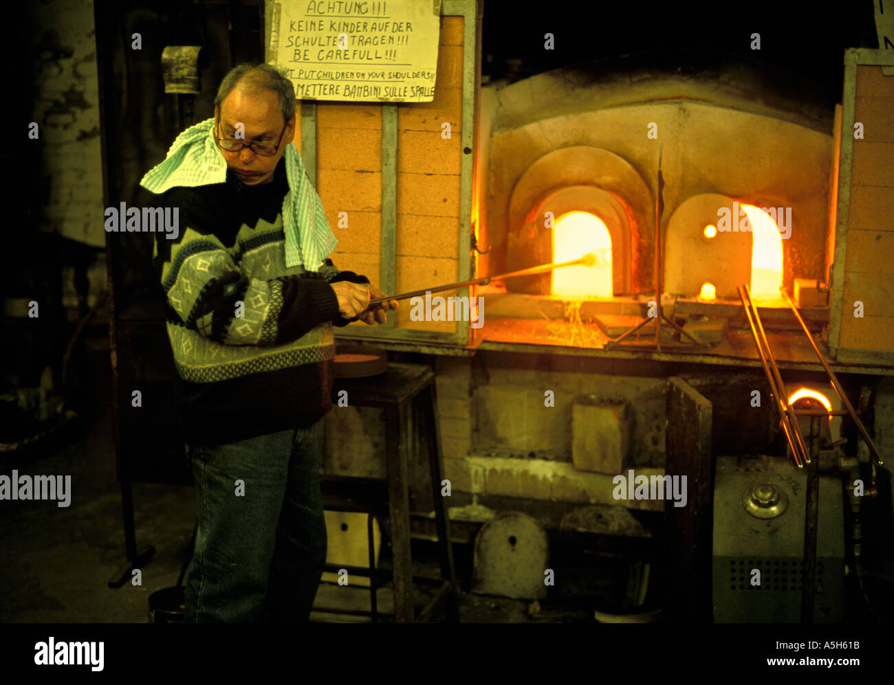 Glass blower at his furnace in Murano glass works Venice Italy Stock ...