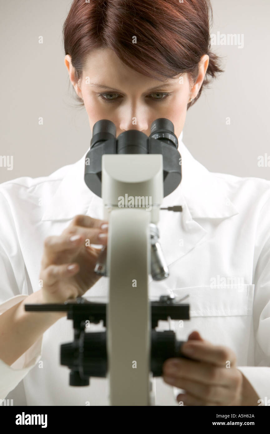 Lab technician at a microscope Stock Photo - Alamy