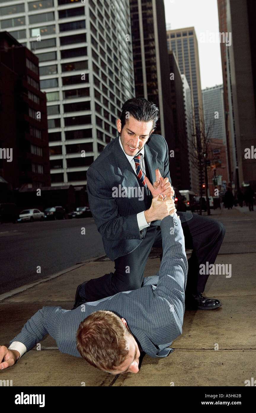Businessmen fighting in street Stock Photo - Alamy