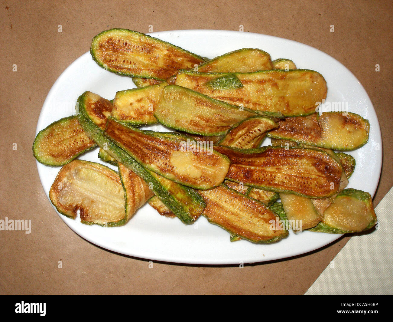 Greek dish, Kolokithakia, or fried courgettes, served as a starter or ...