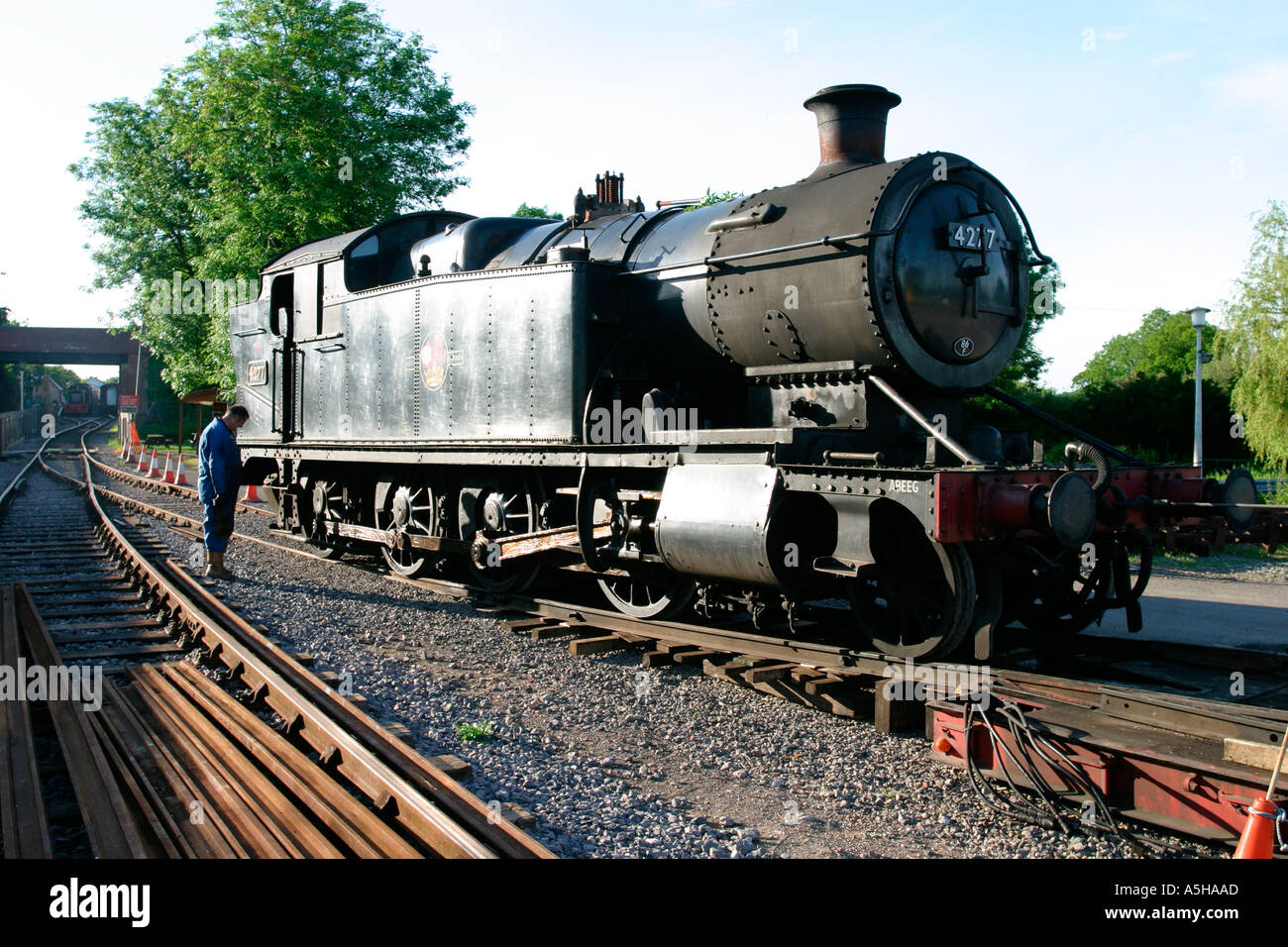 Large steam engine being delivered and unloaded from the back of a ...