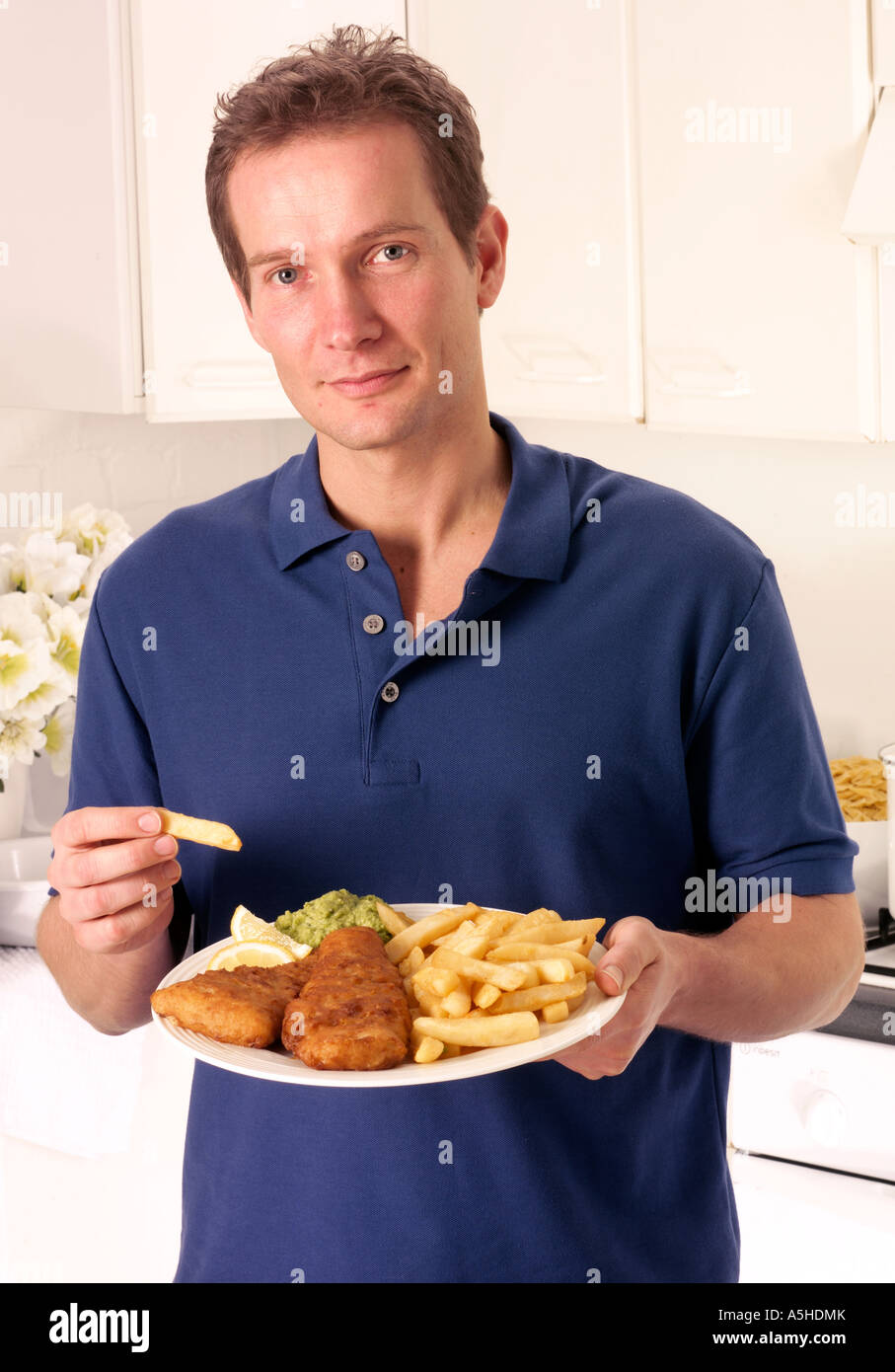 Someone eating fish and chips hi-res stock photography and images - Alamy