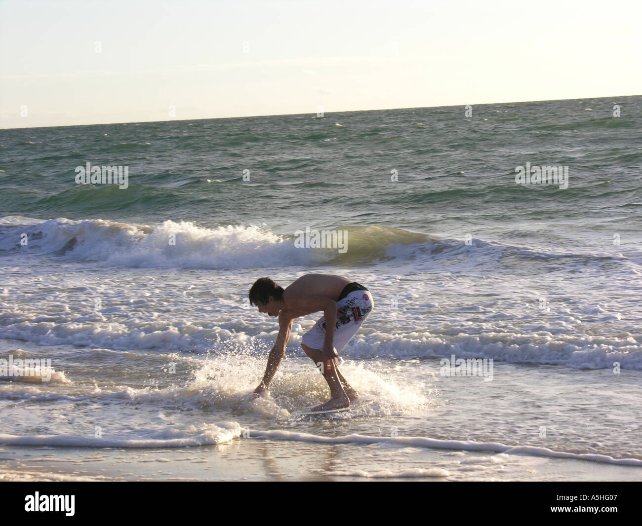 Boy balancing on skimboard Stock Photo - Alamy