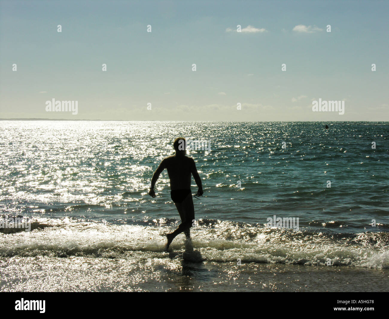 Man running into the sea Stock Photo - Alamy