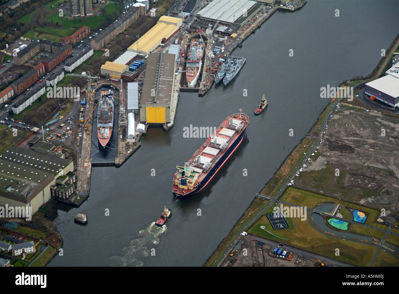 Ship being escorted up the river Clyde, Glasgow February 2007, past ...