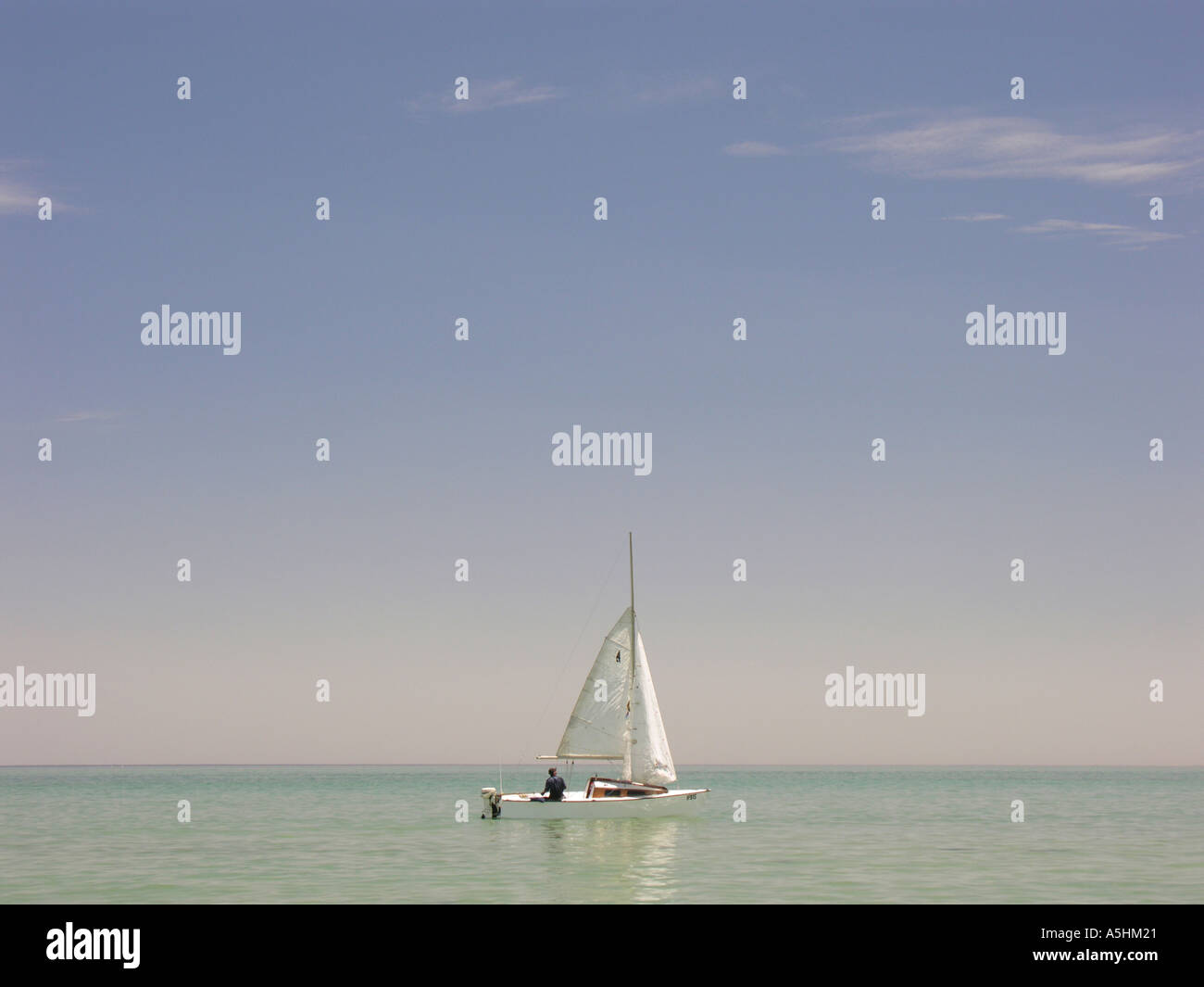 Small sailing boat with skipper Stock Photo - Alamy