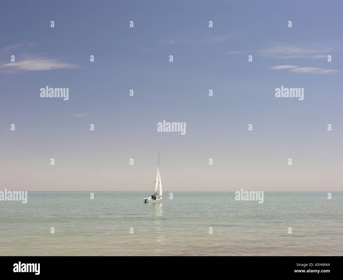 Small sailing boat with skipper Stock Photo - Alamy