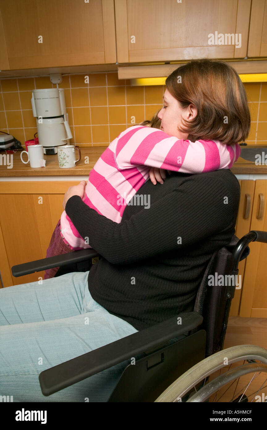 Disabled mother and daughter hugging Stock Photo - Alamy