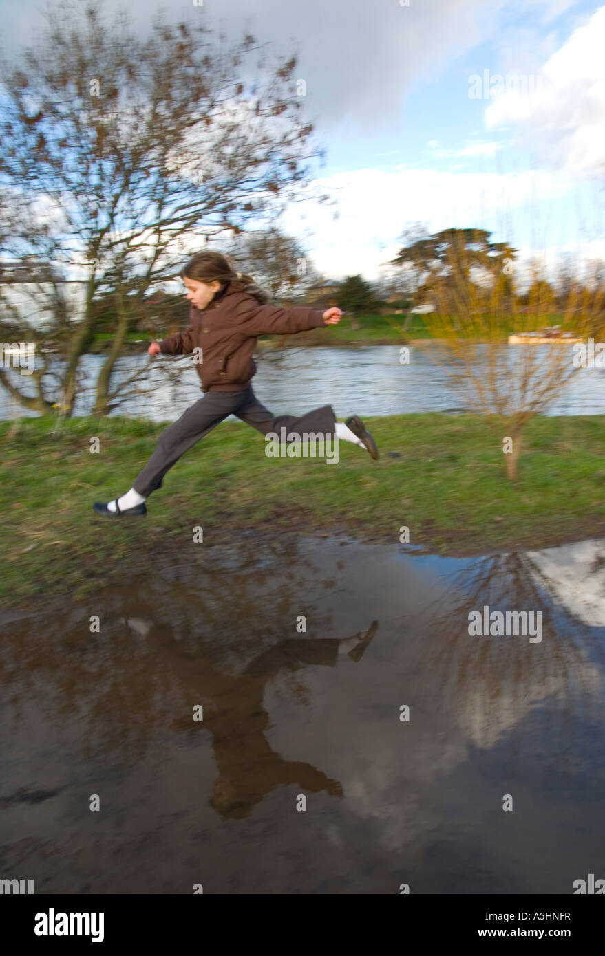 girl child running jumping along riverside path Stock Photo - Alamy