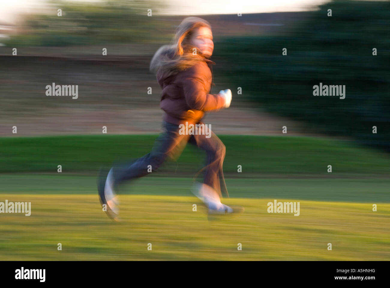 girl child running along parkland Stock Photo - Alamy