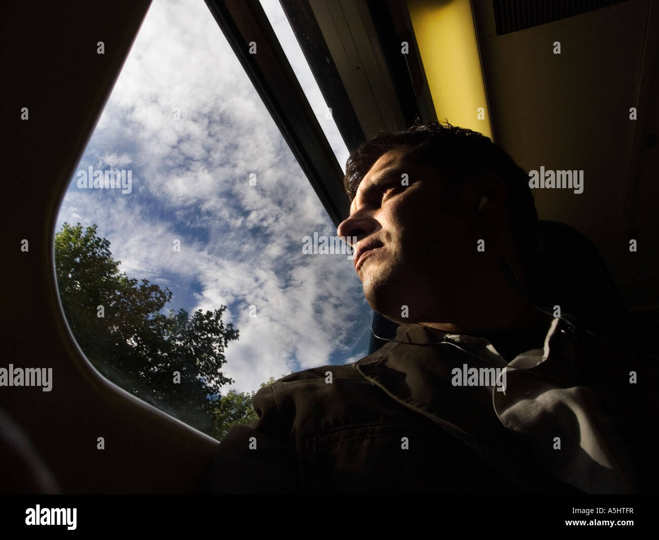commuter looking through a train window alone Stock Photo - Alamy