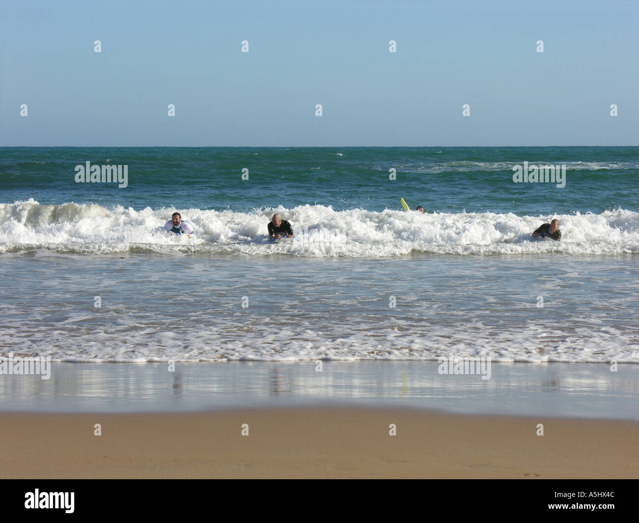 Young adults boogie-boarding in the surf Stock Photo - Alamy